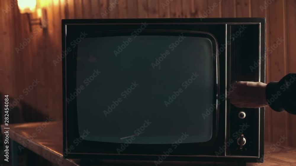 Male hand changing the channels on the Old Television. An electrical ...
