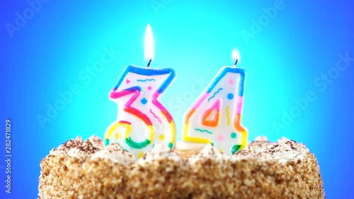 Birthday cake with a burning birthday candle. Number 34. Background ...