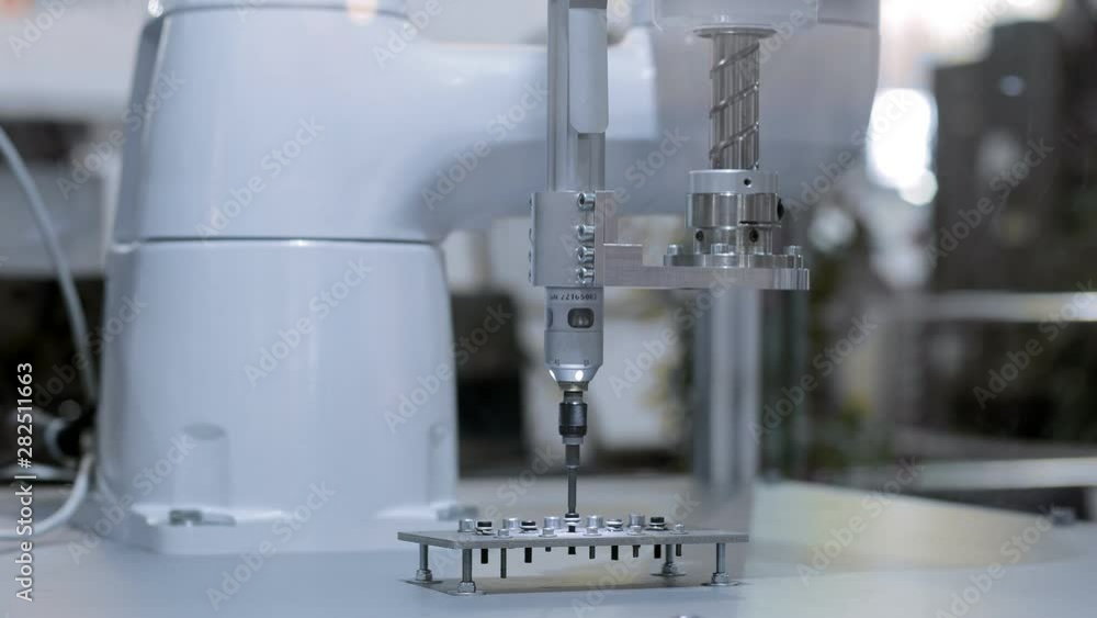 Automatic robot arm working in industrial environment closeup footage ...