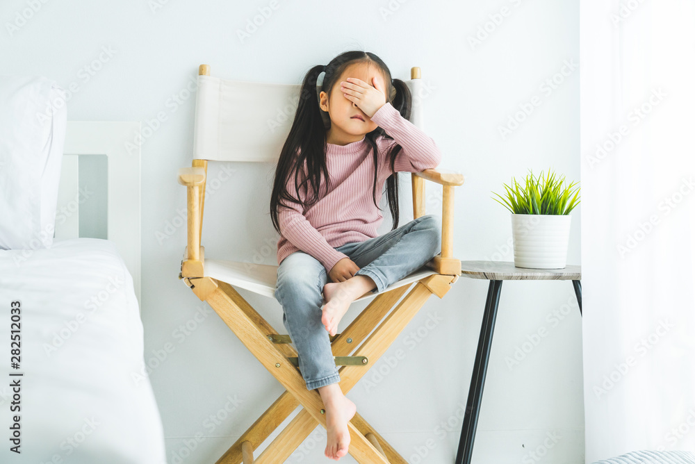 child girl stressed about family problems sit on chair at home crying ...