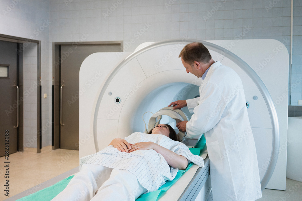 Doctor preparing patient for MRI in hospital Stock Photo | Adobe Stock