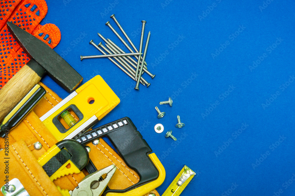 Professional tools for the joiner and spare parts on a blue background ...