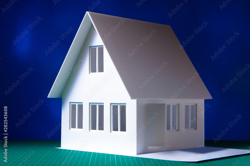 Model house with white walls. Two-storey cottage on a dark background ...