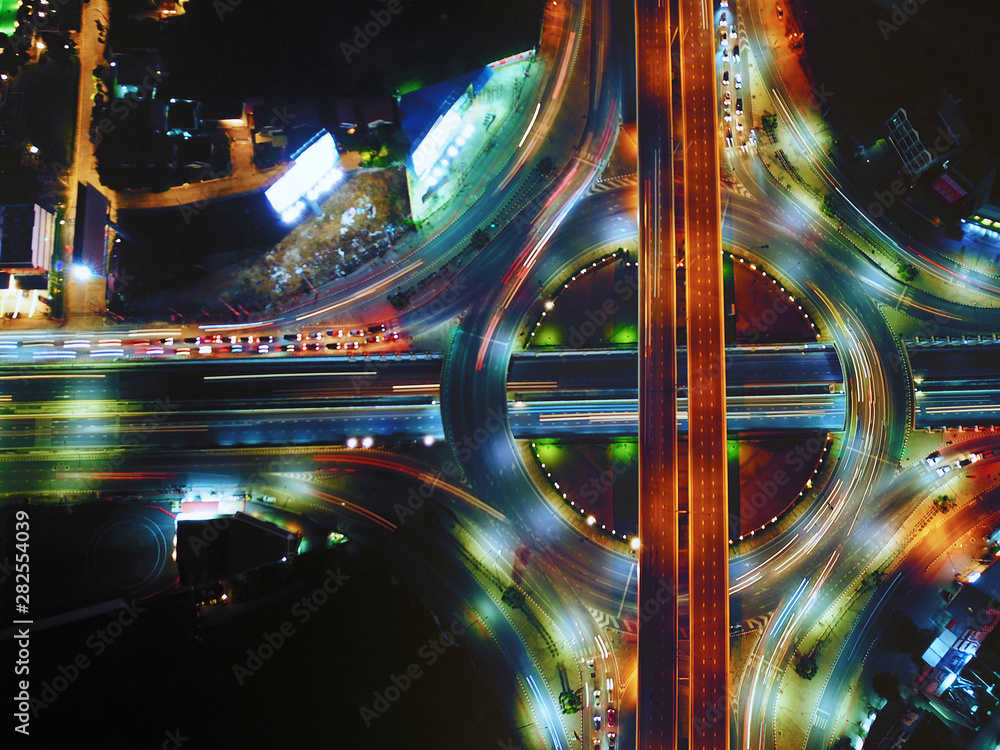 Aerial view of Circle Road traffic in roundabout and highway at night ...