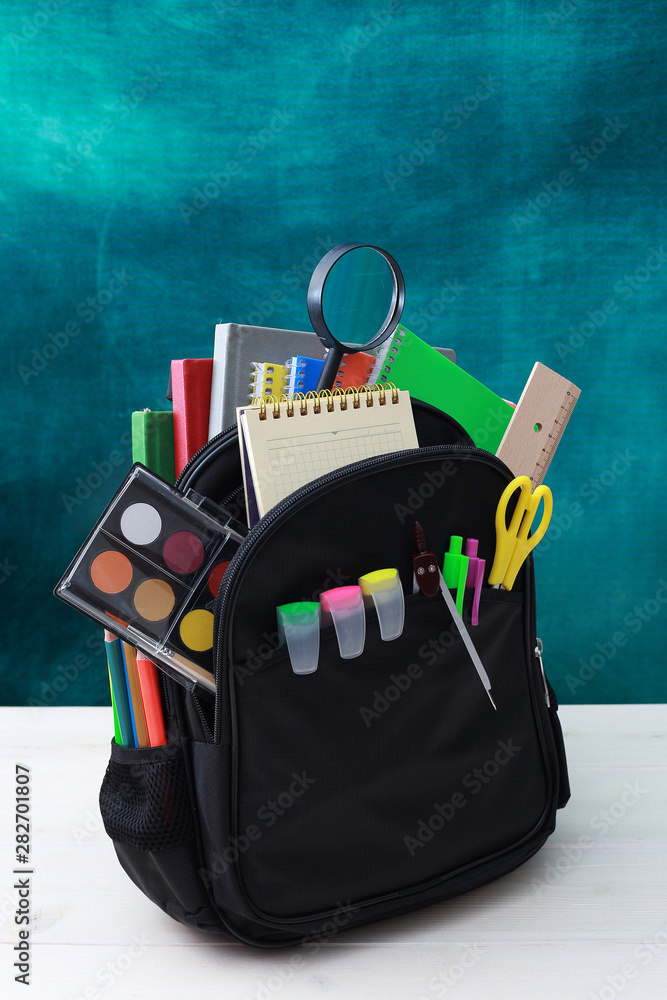 Back to school concept. School bag, pencils, crayons, scissor ...