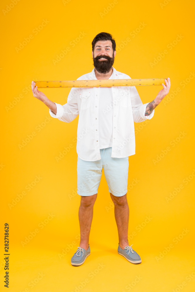 One meter. Man bearded hipster holding ruler. Measure length. Size tall ...