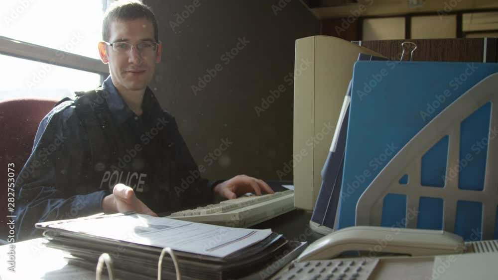Police officer in precinct solving crimes Stock Video | Adobe Stock