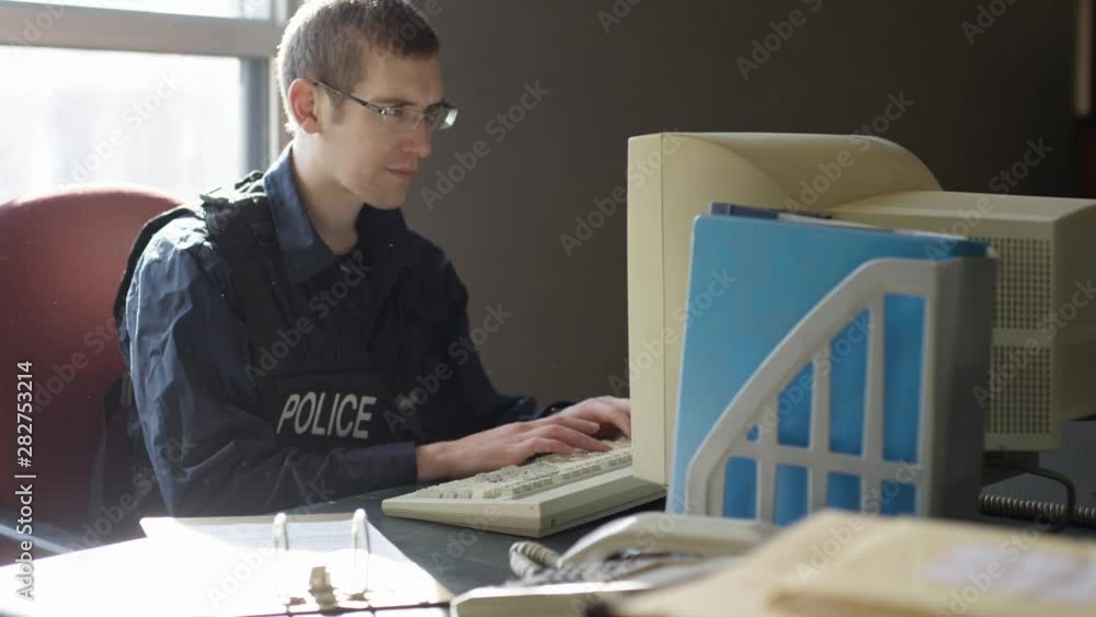 Police officer in precinct solving crimes Stock Video | Adobe Stock