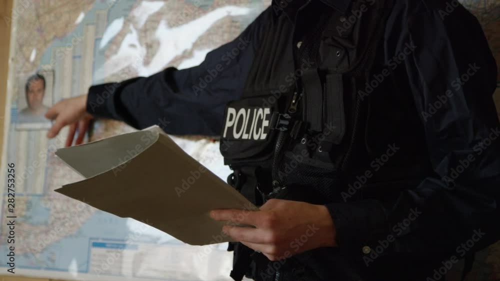 Police officer in precinct solving crimes Stock Video | Adobe Stock