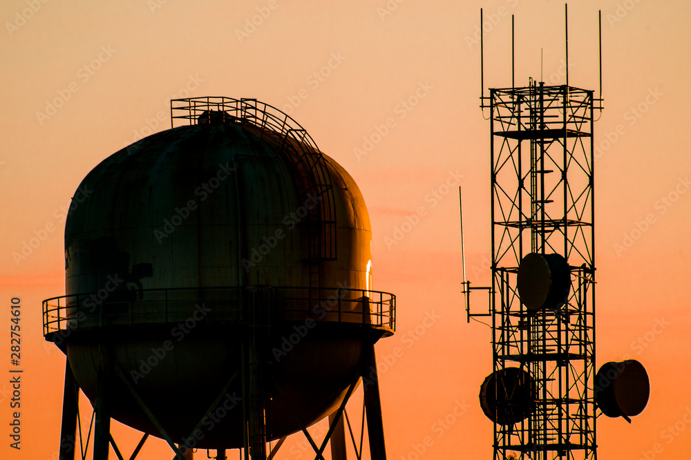 water storage tank next to cell phone tower Stock Photo | Adobe Stock