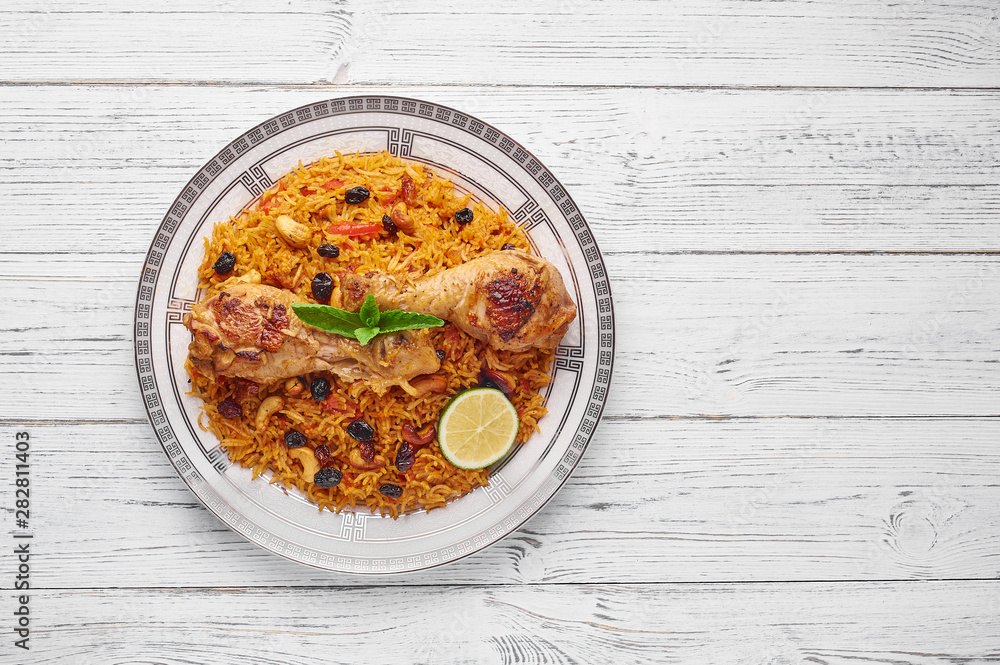 Chicken Kabsa or Chicken biryani at white wooden background. Kabsa is ...