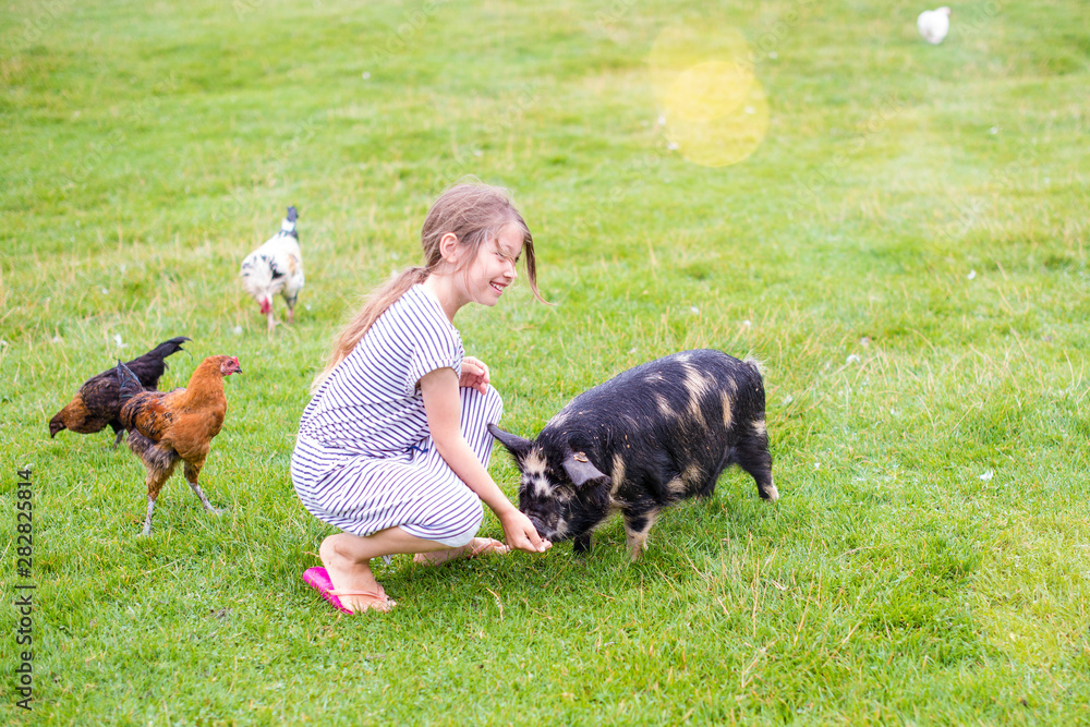 Poster pretty little girl taking care of a dwarf pig – Wall Art | UkPosters