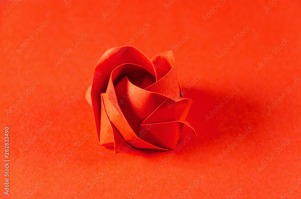 Red origami rose on red background. Japanese art of paper folding. Flat ...
