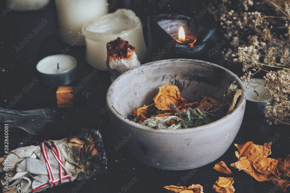 Close up of dried plants, herbs and yellow rose flower petals in a grey ...