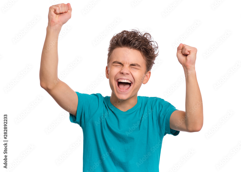 Portrait of successful teen boy winner with raised hands and clenching ...