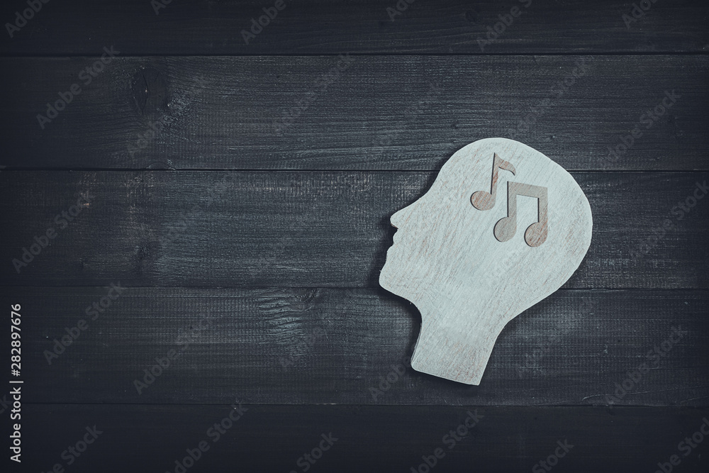 Human head and face with music note sign on wood table background ...