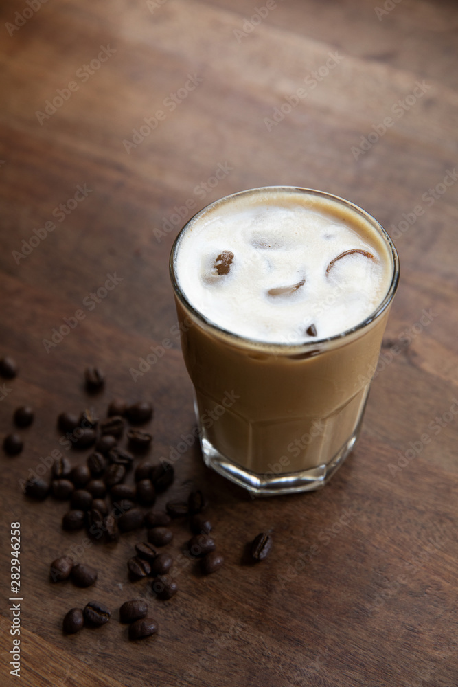 Iced coffee over a wood surface, coffee beans on the side. Stock Photo ...
