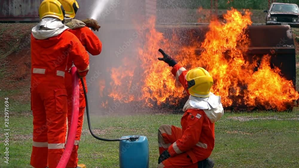 HD Slow motion wide shot of firefighter in fire suit on safety rescue ...