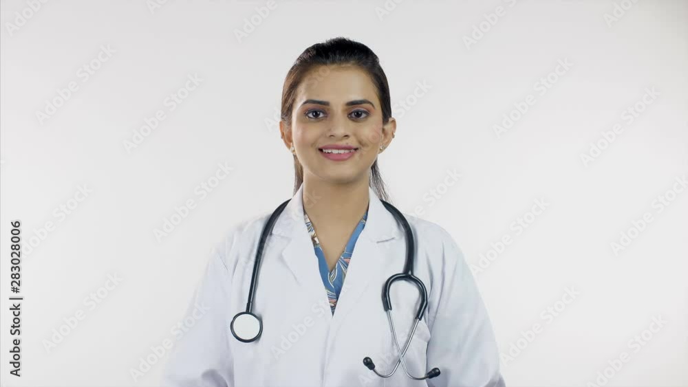 Young beautiful female doctor happily smiling in a white coat - medical ...