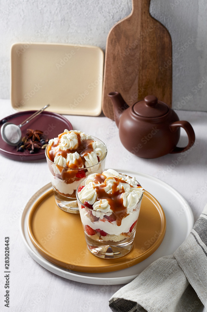 Layered dessert Trifle with vanilla cake, whipped cream, salted caramel ...