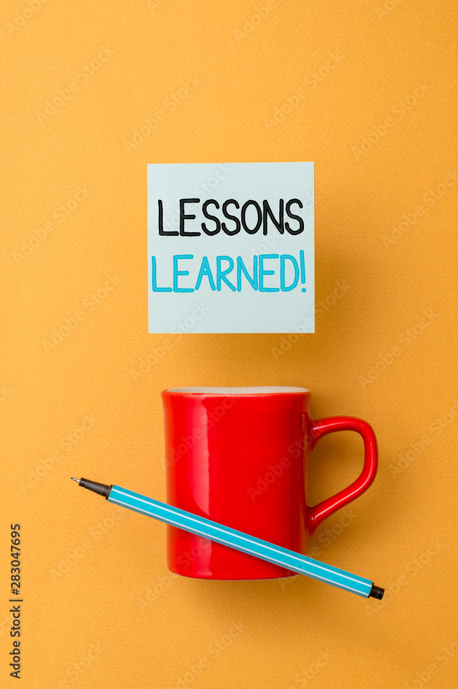 Writing note showing Lessons Learned. Business concept for experiences ...