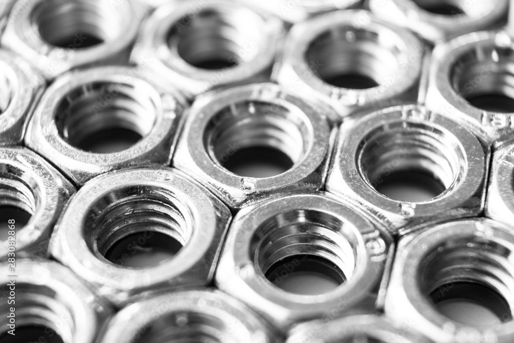 Metal nuts in a row background. Chromed screw nuts isolated. Steel nuts ...