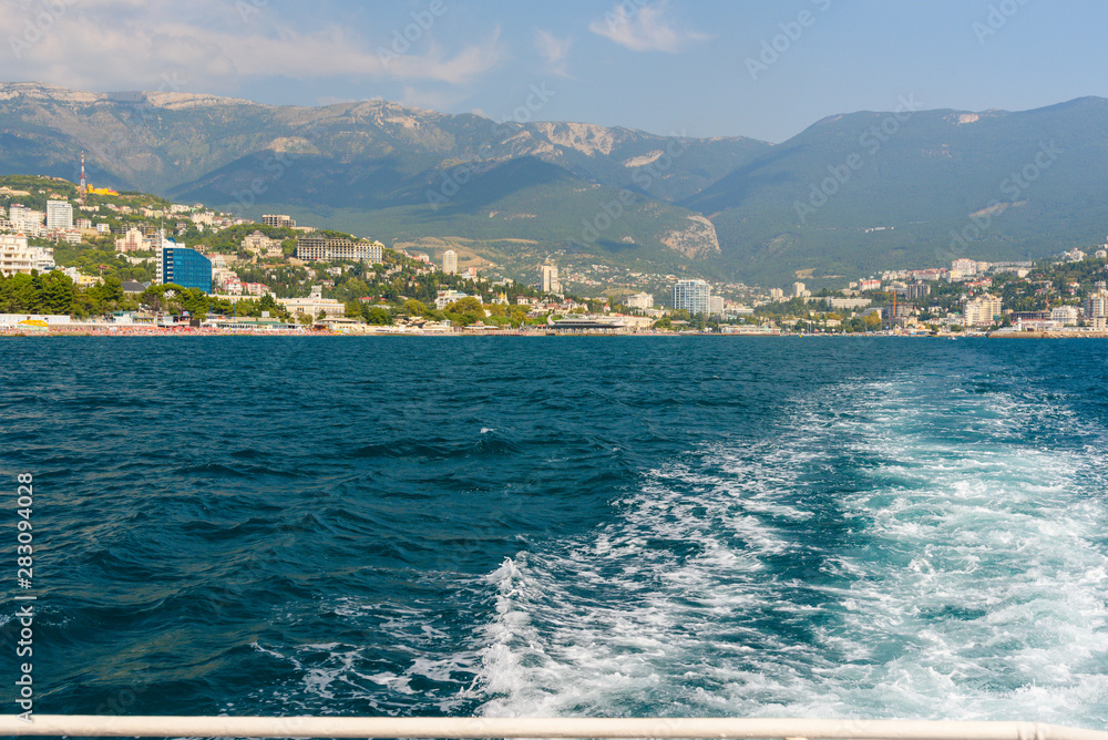the trail from the pleasure boat on the sea, the coast of the resort ...