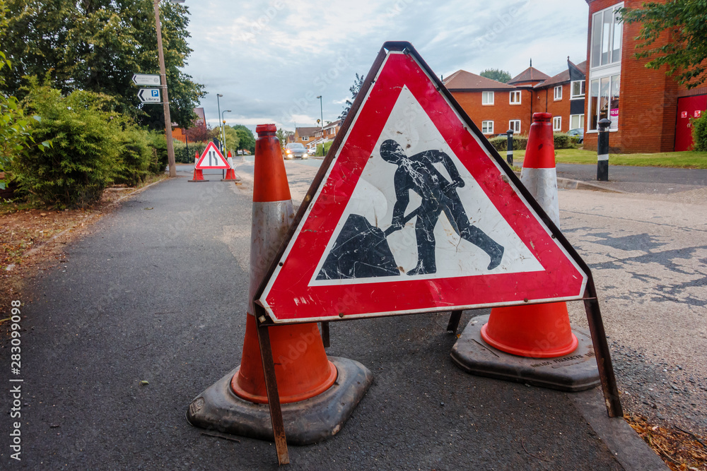 Road signs warning motorists and pedestrians or roadworks further down ...
