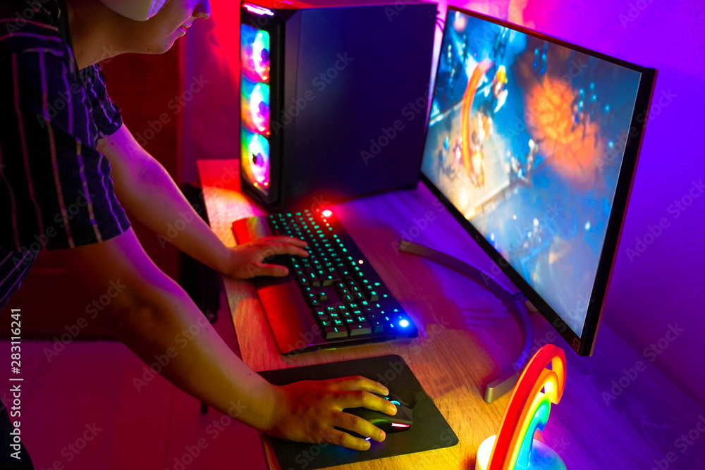 Young gamer playing video game wearing bluethoot headphone. Gamer ...