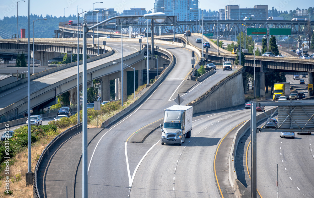 Big rig semi truck transporting commercial cargo running on the multi ...