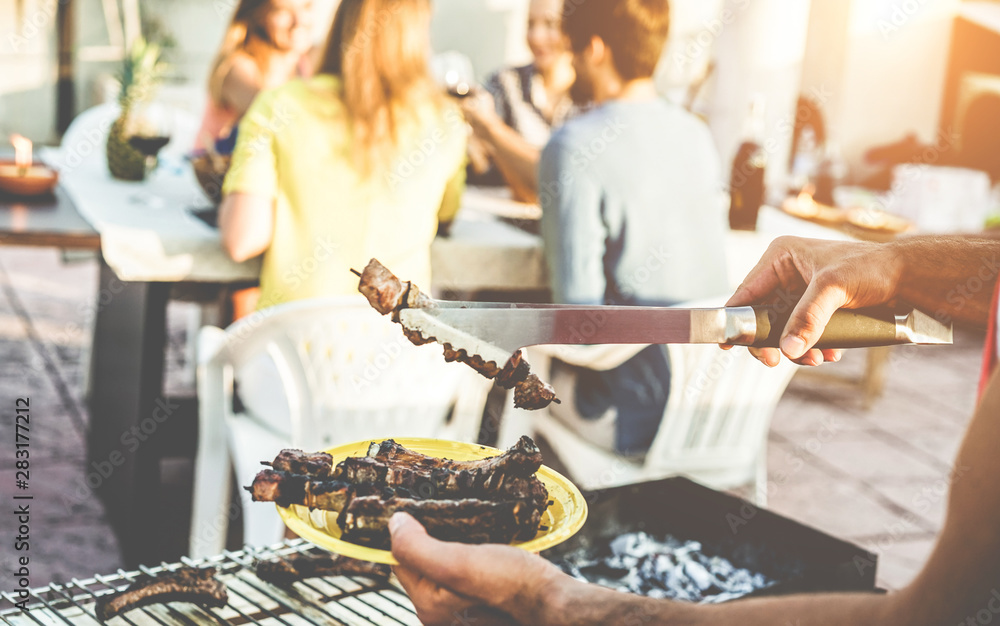 Young friends having barbecue party at sunset on penthouse patio ...