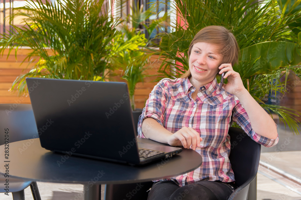 young girl talking on a cell phone works on a computer Stock Photo ...