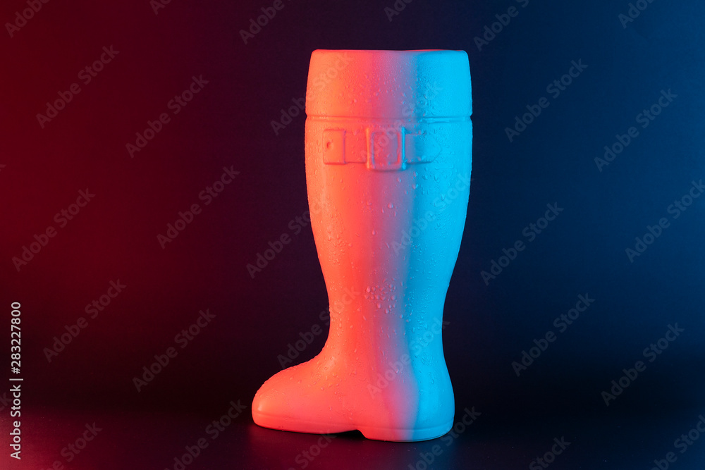 Beer porcelain boot shaped stein on a black background with a red and ...