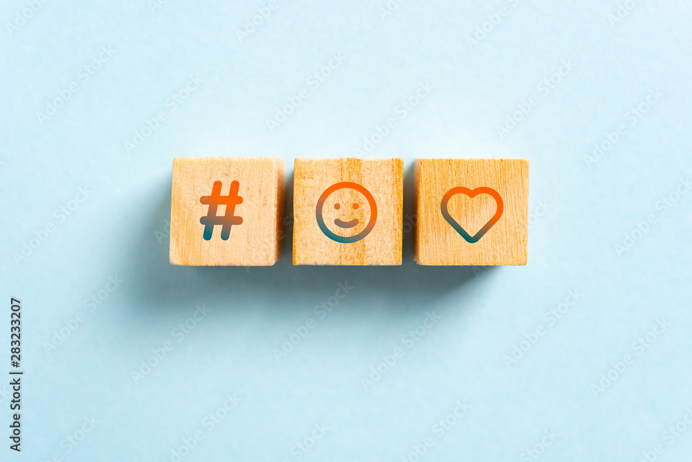 Social media icons. Hashtag, happy smiling face and heart icons on wood ...