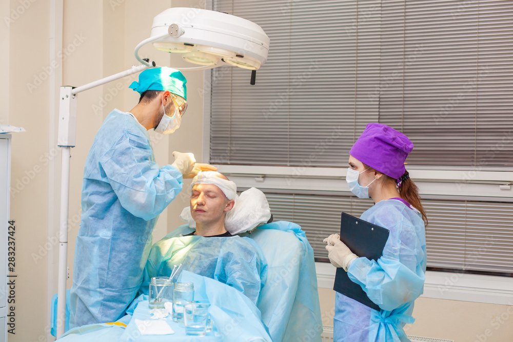 The surgeon gives injections to the head. Baldness treatment. Hair ...
