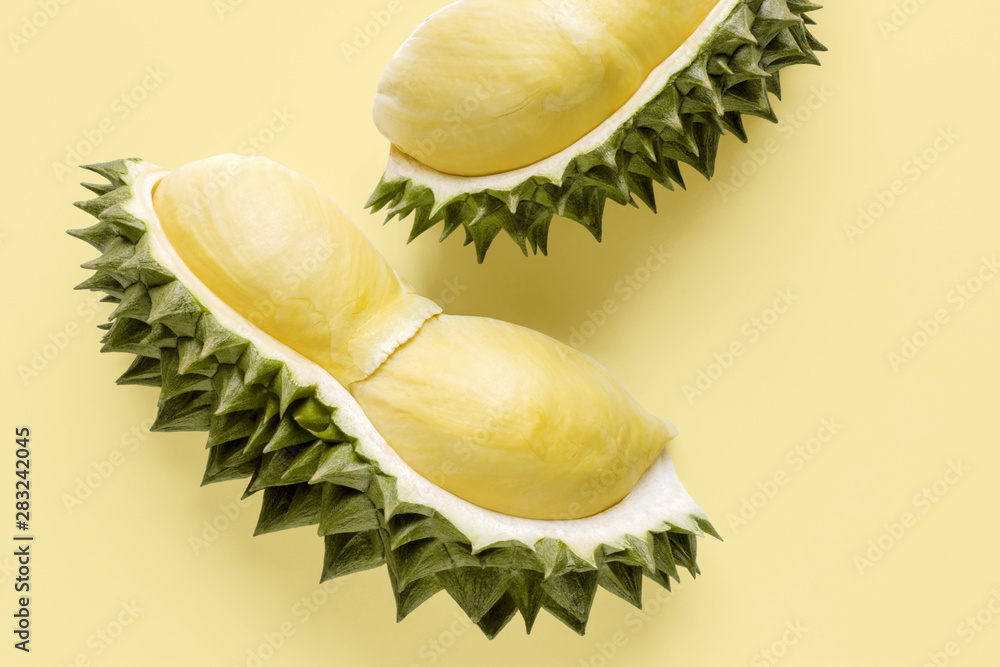 Fresh cut durian on a yellow background, king of fruit from Thailand ...