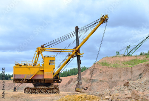 Huge mining excavator in the limestone open-pit. Biggest digger working ...