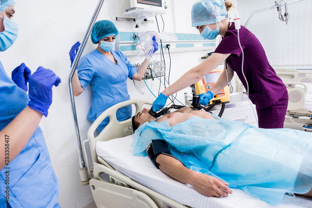 Doctors give resuscitation to a male patient in the emergency room ...