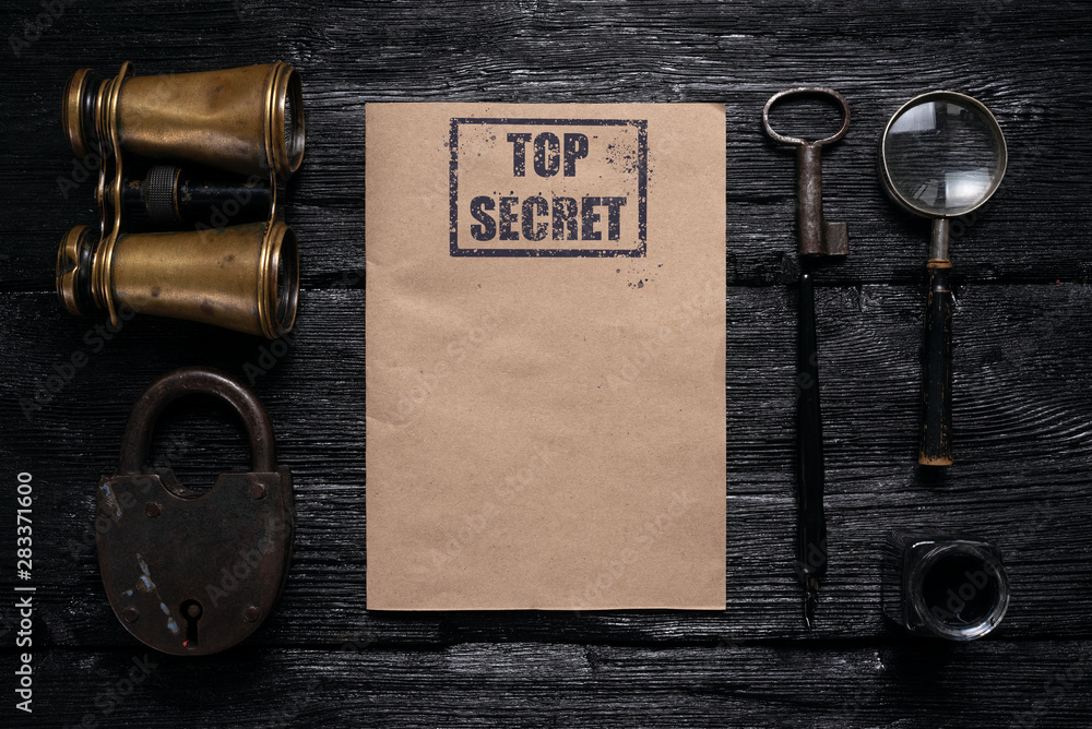 Top secret document mock up on a black wooden table background. Blank ...