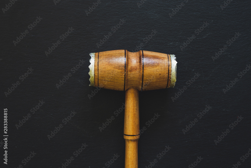 Big wooden meat hammer with metallic edges placed in the middle of a ...