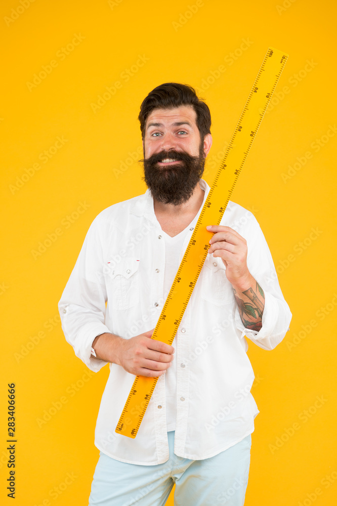Man bearded hipster holding ruler. Measure length. Size tall and length ...
