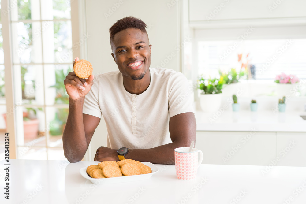 African american man eating healthy whole grain biscuit with a happy ...
