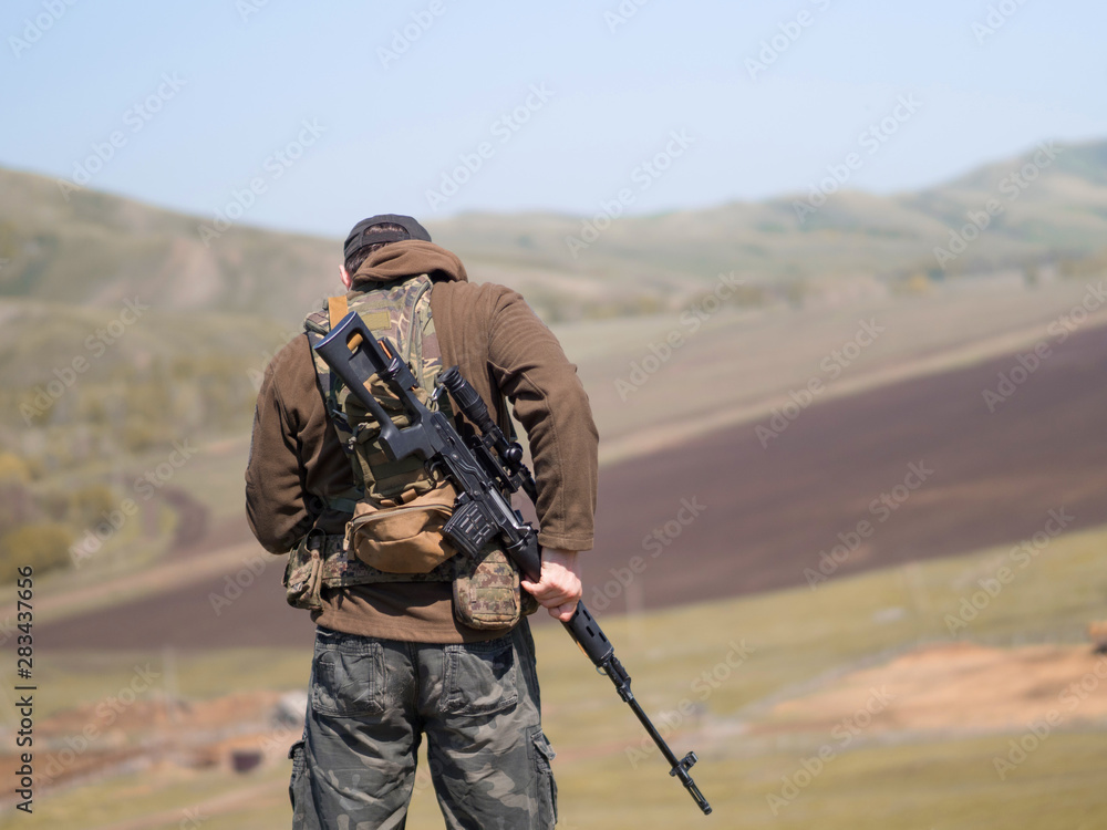 Military man with sniper rifle SVD, view from the back. Stock Photo ...