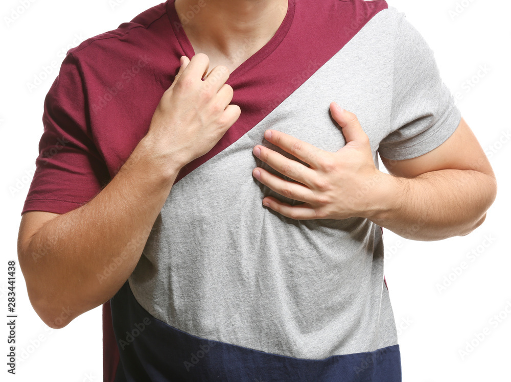 Young man suffering from heart attack on white background, closeup ...