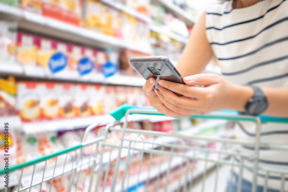 A beautiful Asian woman holding a calculator to calculate the cost and ...