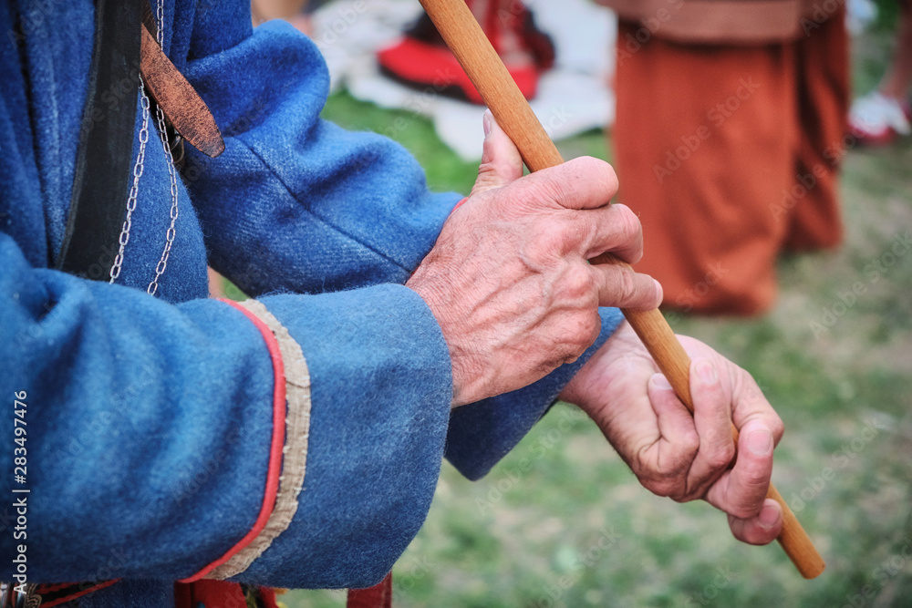 The flutist plays a national musical instrument. An old man dressed in ...