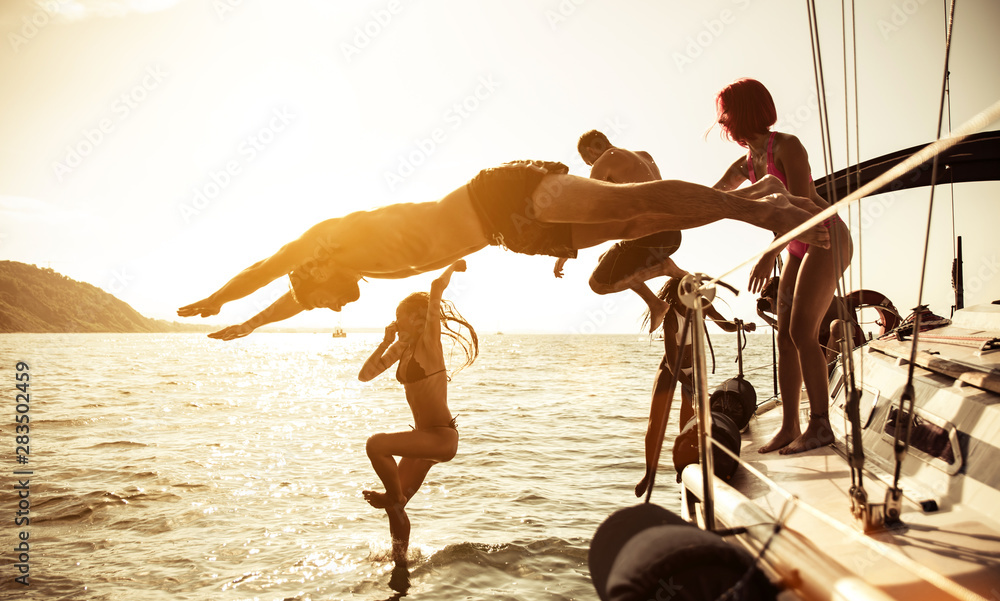 group of friends diving in the water during a boat excursion Stock ...