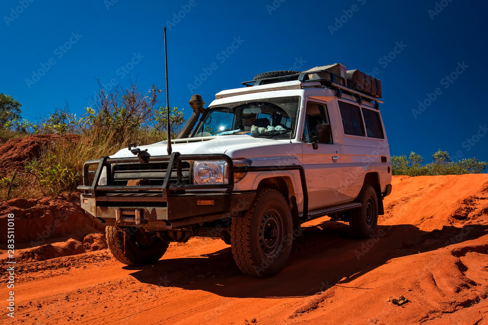 Western Australia – Outback track with 4WD car downhill to the ocean at ...