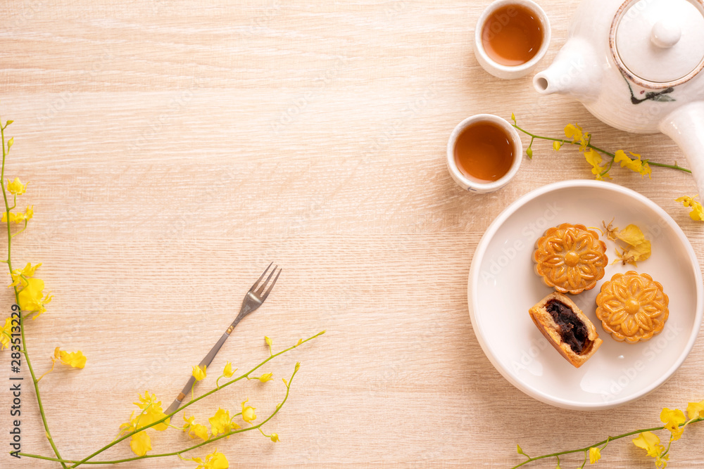 Tasty moon cake for Mid-Autumn festival on bright wooden table, concept ...