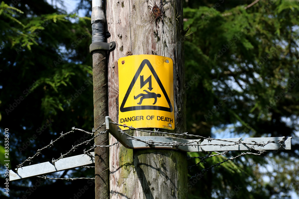 Electricity Danger Sign on a Timber Pylon Stock Photo | Adobe Stock
